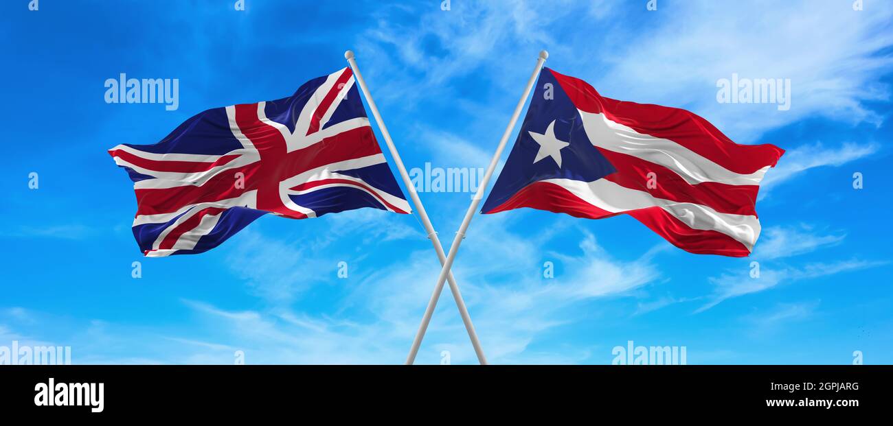 flags of great Britain and Puerto Rico waving in the wind on flagpoles ...