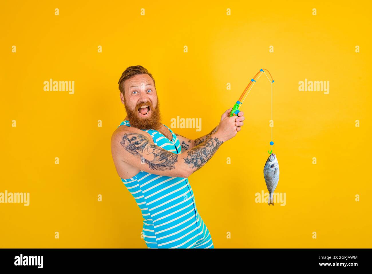 man with beard and swimsuit caught a fish Stock Photo - Alamy