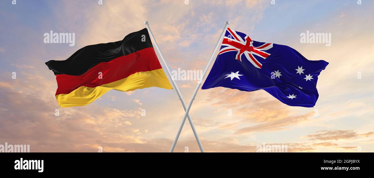 flags of Germany and Australia waving in the wind on flagpoles against ...