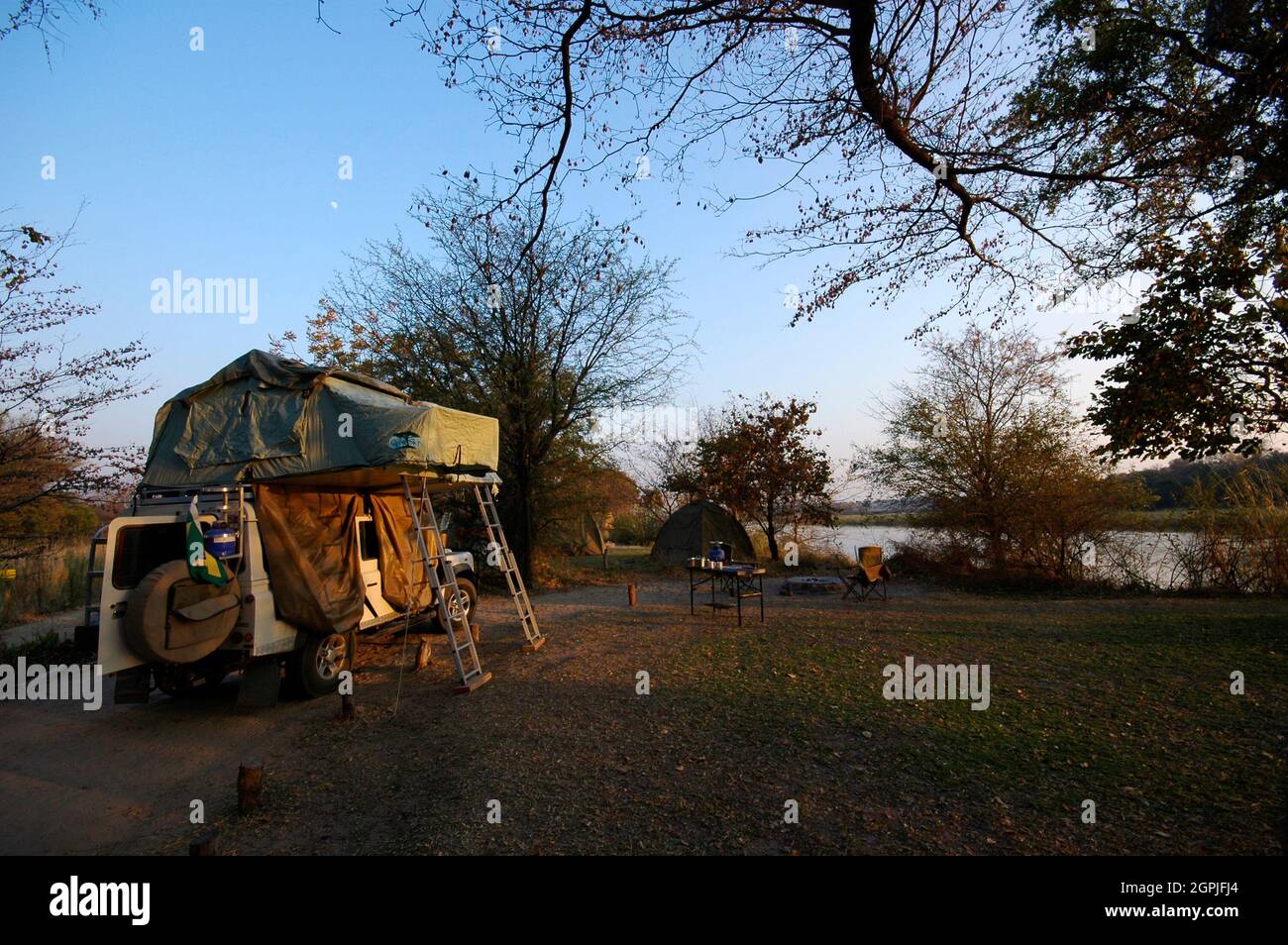 Land Rover Defender 110 on the shores of the Okavango river at Ngepi ...
