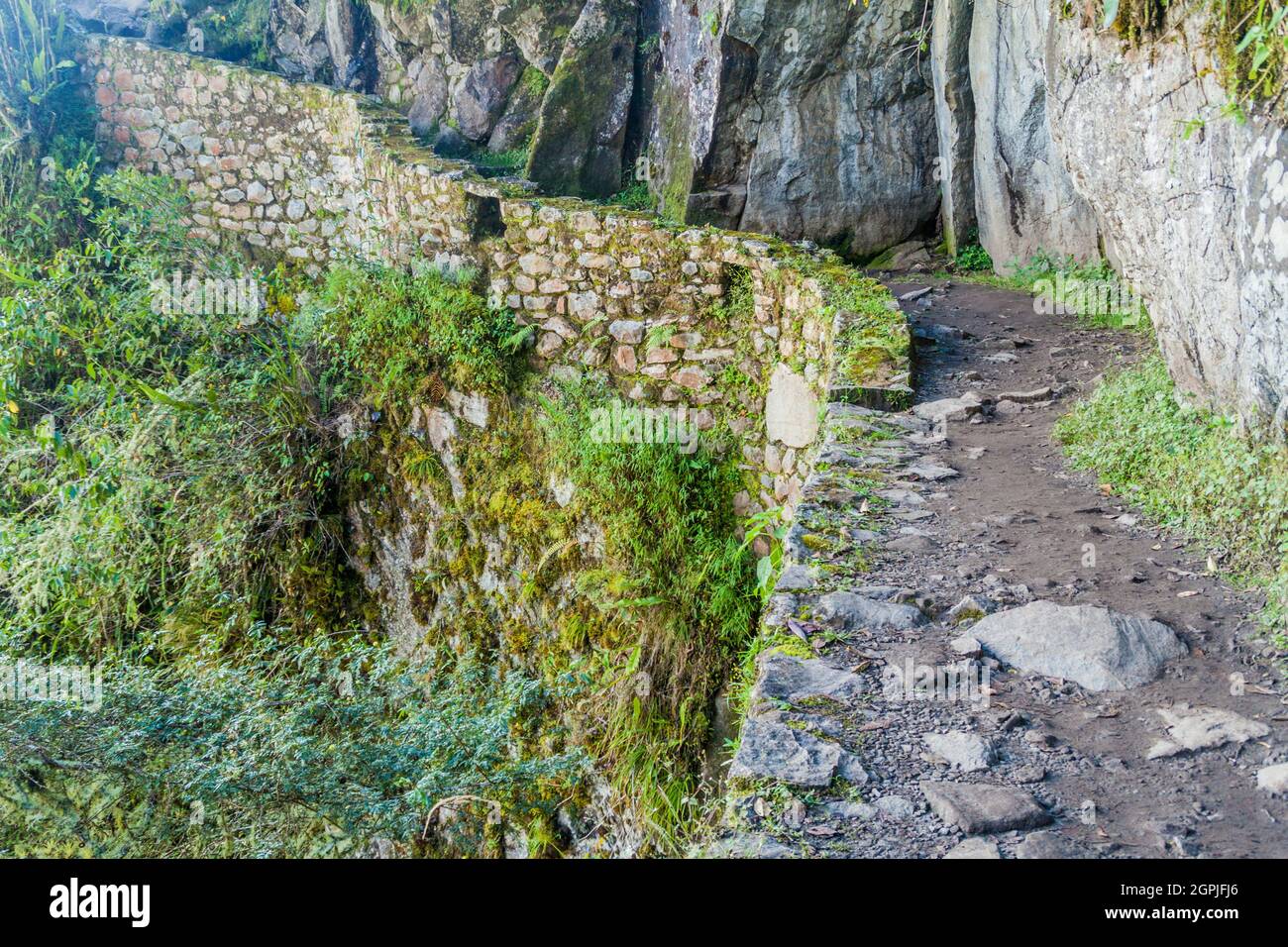 Inca trail carved into a stone wall near Machu Picchu ruins, Peru Stock ...