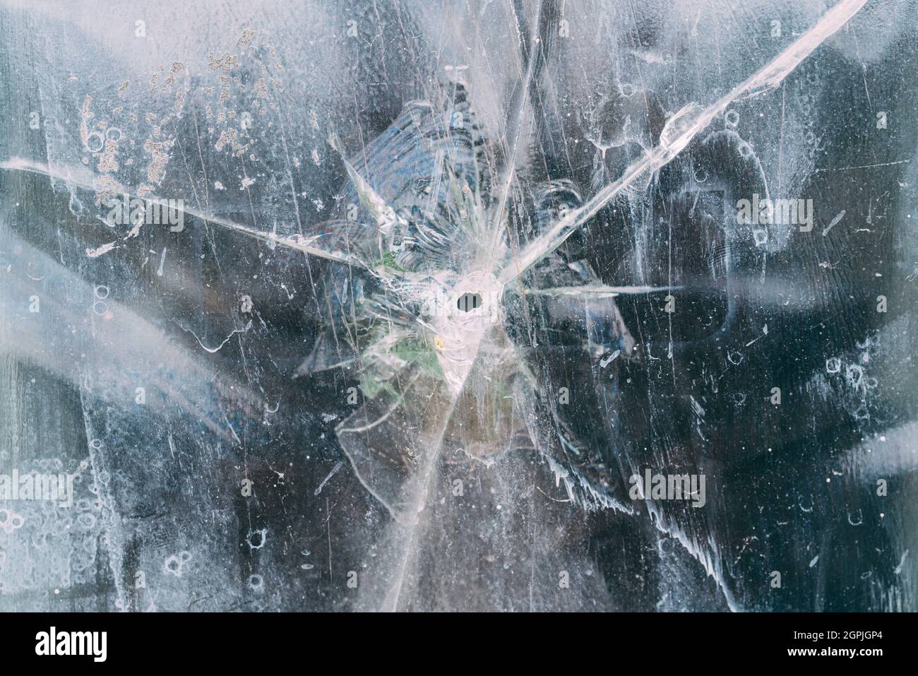 Bullet shattered window glass with a hole Stock Photo - Alamy