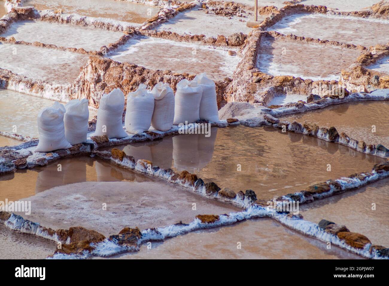 Bags of salt at salt extraction pans (Salinas) in Sacred Valley of ...