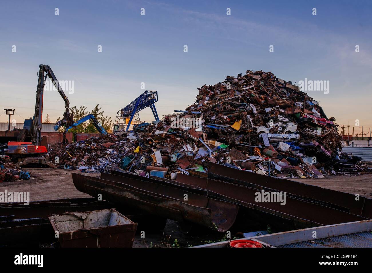 Metal recycling industry. Gripper excavator working on a scrap yard ...