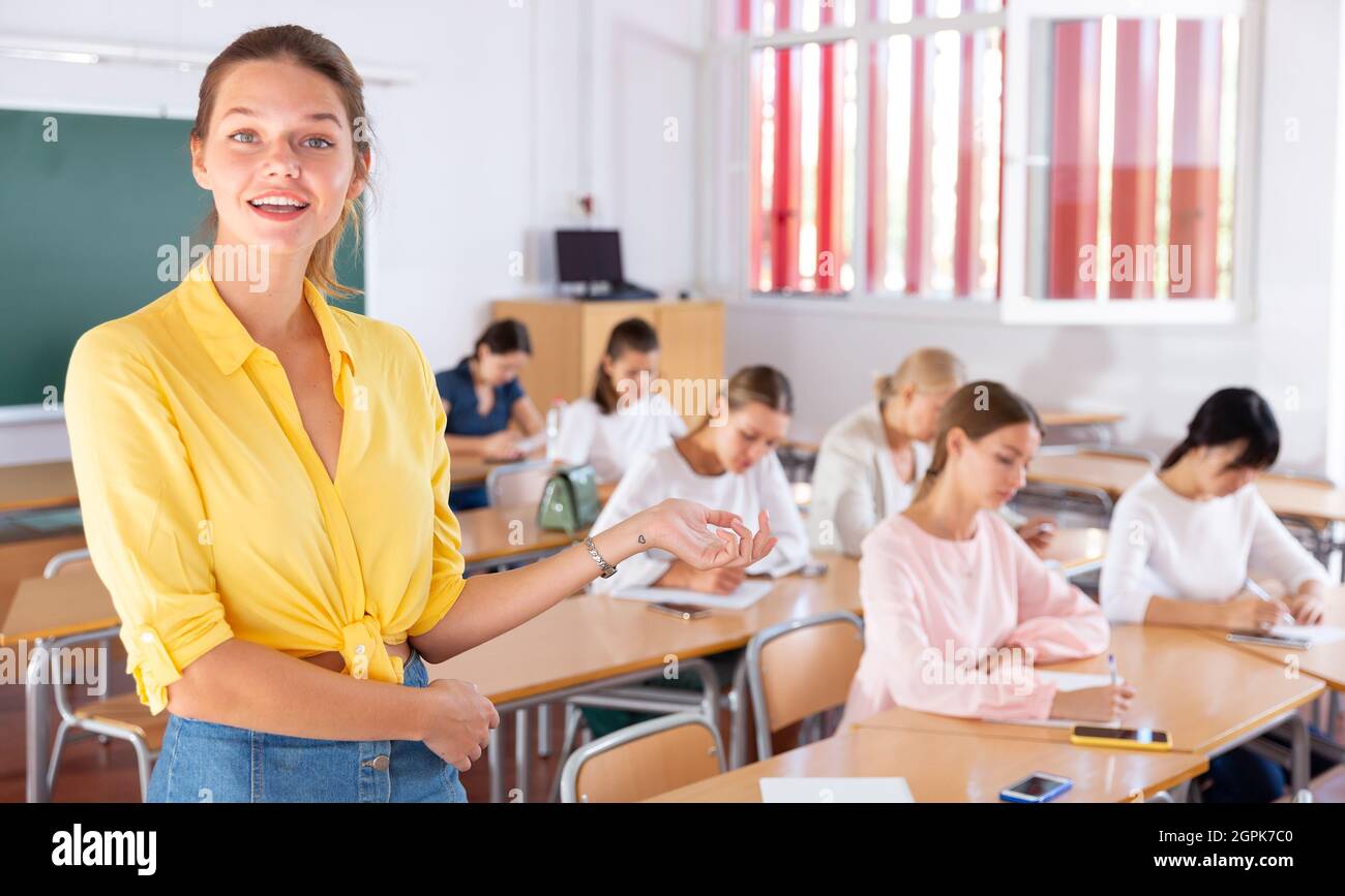 Smiling female student standing in classroom Stock Photo - Alamy