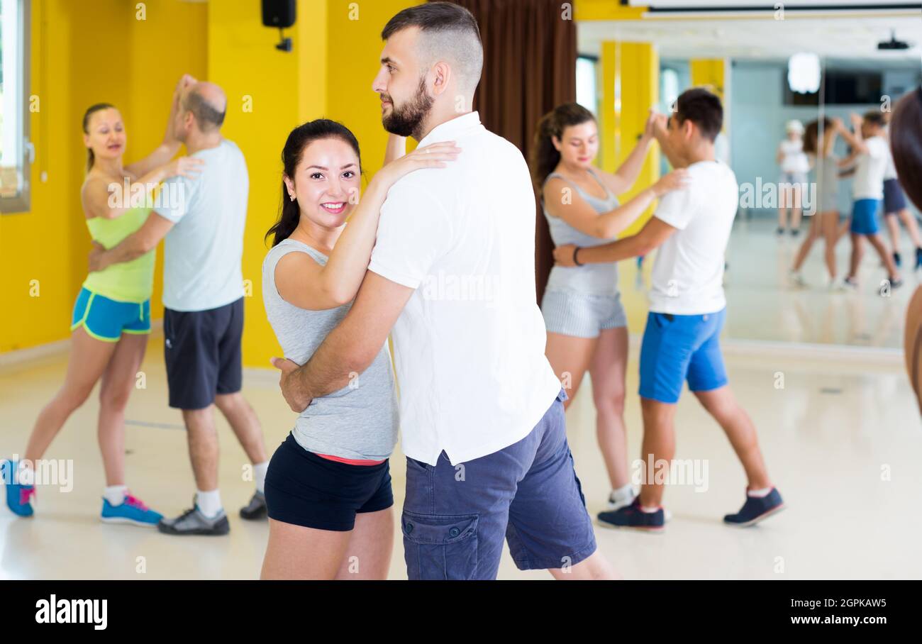 Positive men and women dancing salsa Stock Photo - Alamy