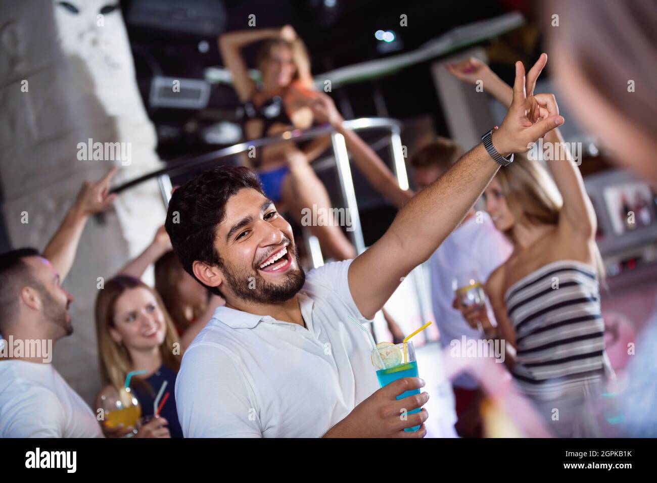 positive male joying and thumbs up on party in the club with coc Stock ...