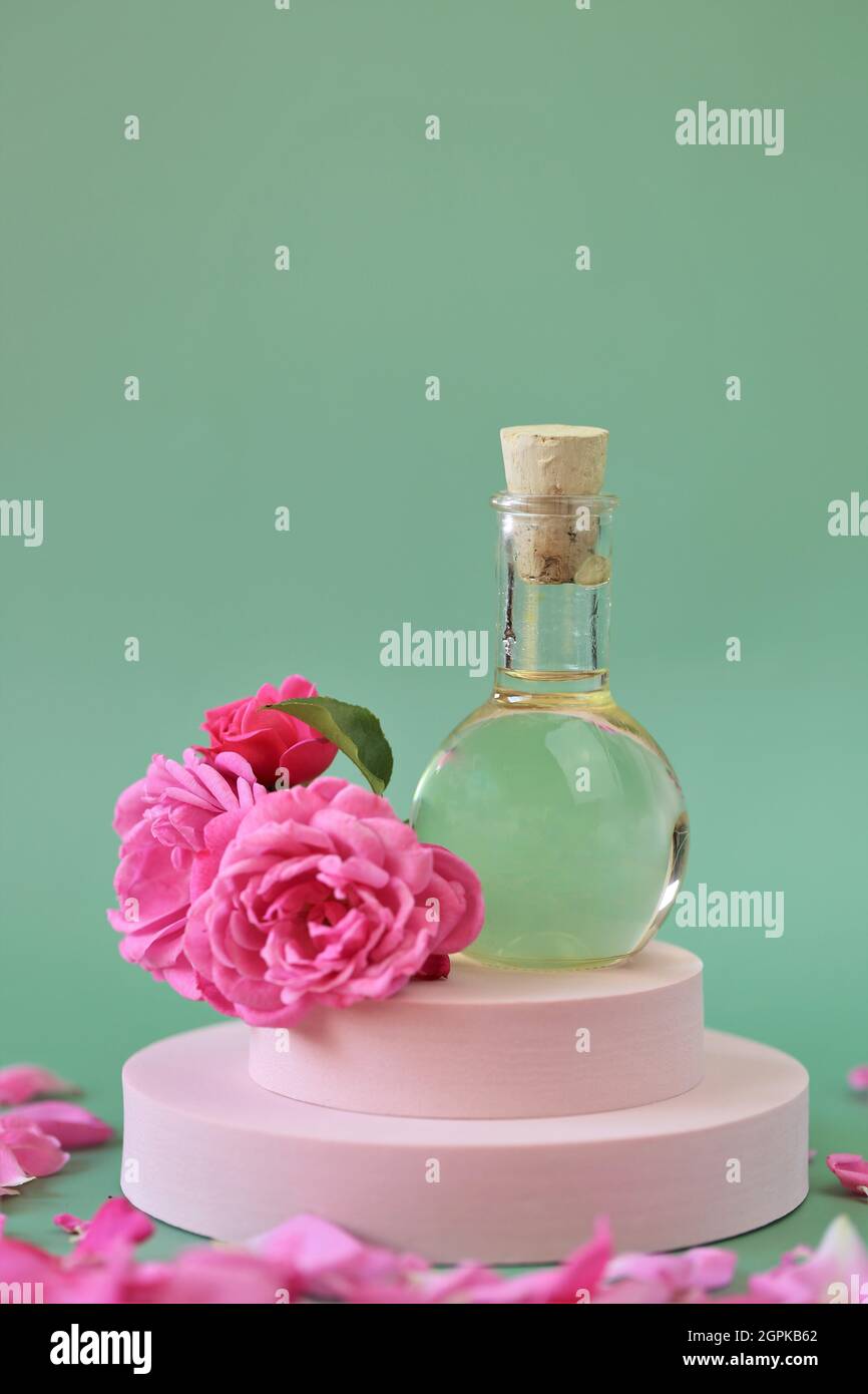 Essential rose oil. Aromatherapy and massage.Rose oil and pink roses ...
