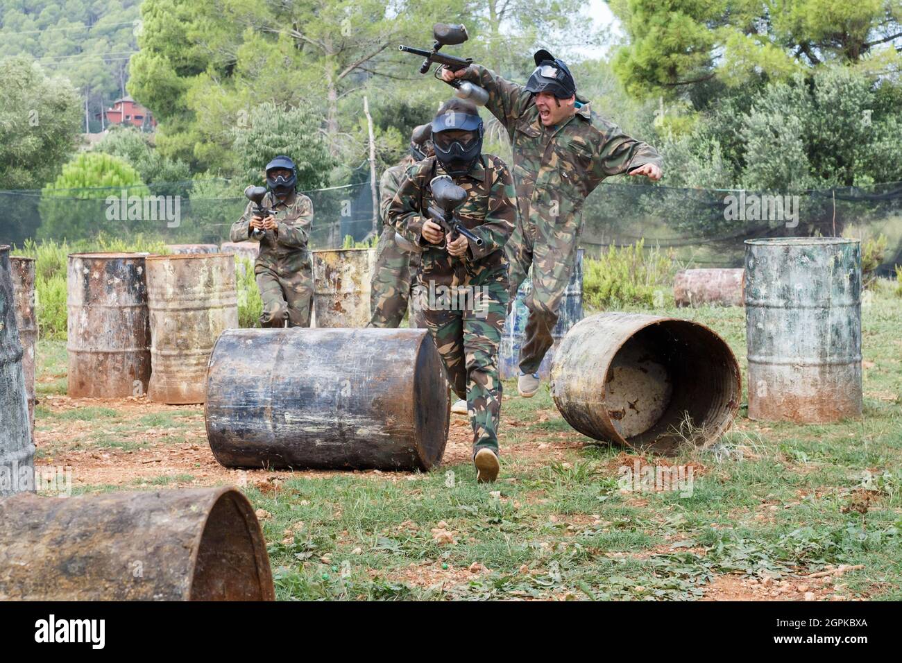 Group of people playing paintball Stock Photo - Alamy