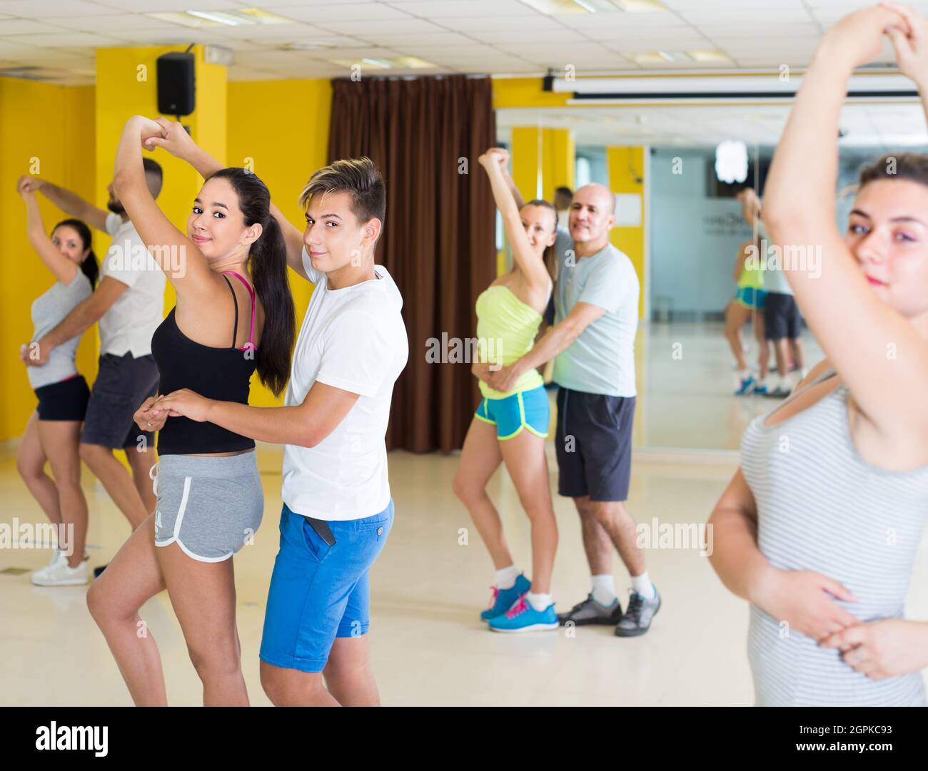 Emotional dancing couples learning salsa Stock Photo - Alamy