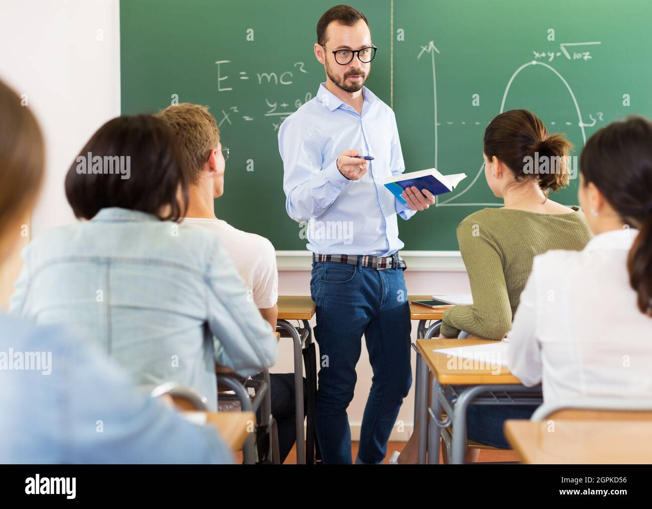 Male teacher giving lecture for students Stock Photo - Alamy