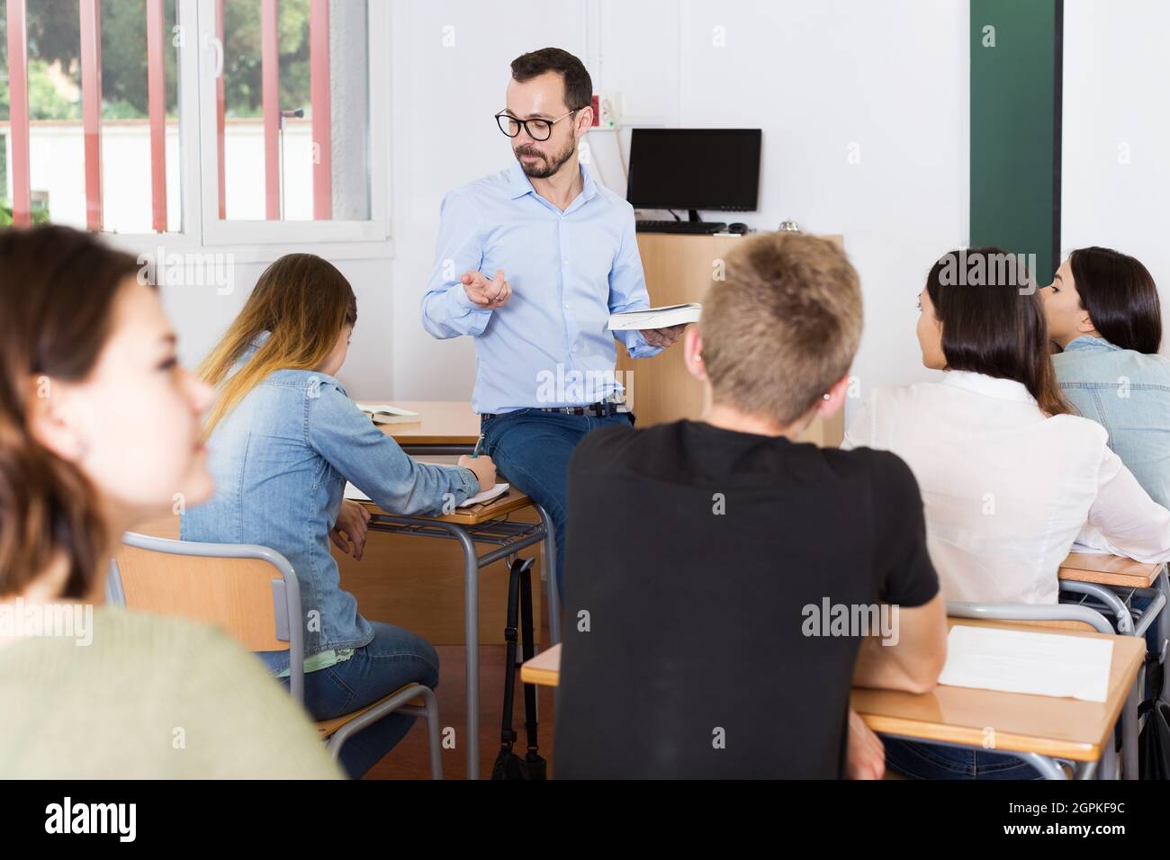 Teacher is giving lecture for students Stock Photo - Alamy