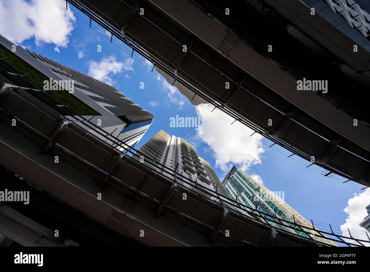 Ground angle photo looking directly up towards highrise towers in the ...