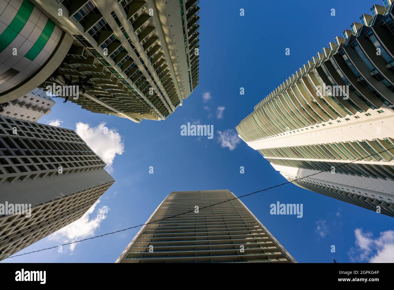 Ground angle photo looking directly up towards highrise towers in the ...