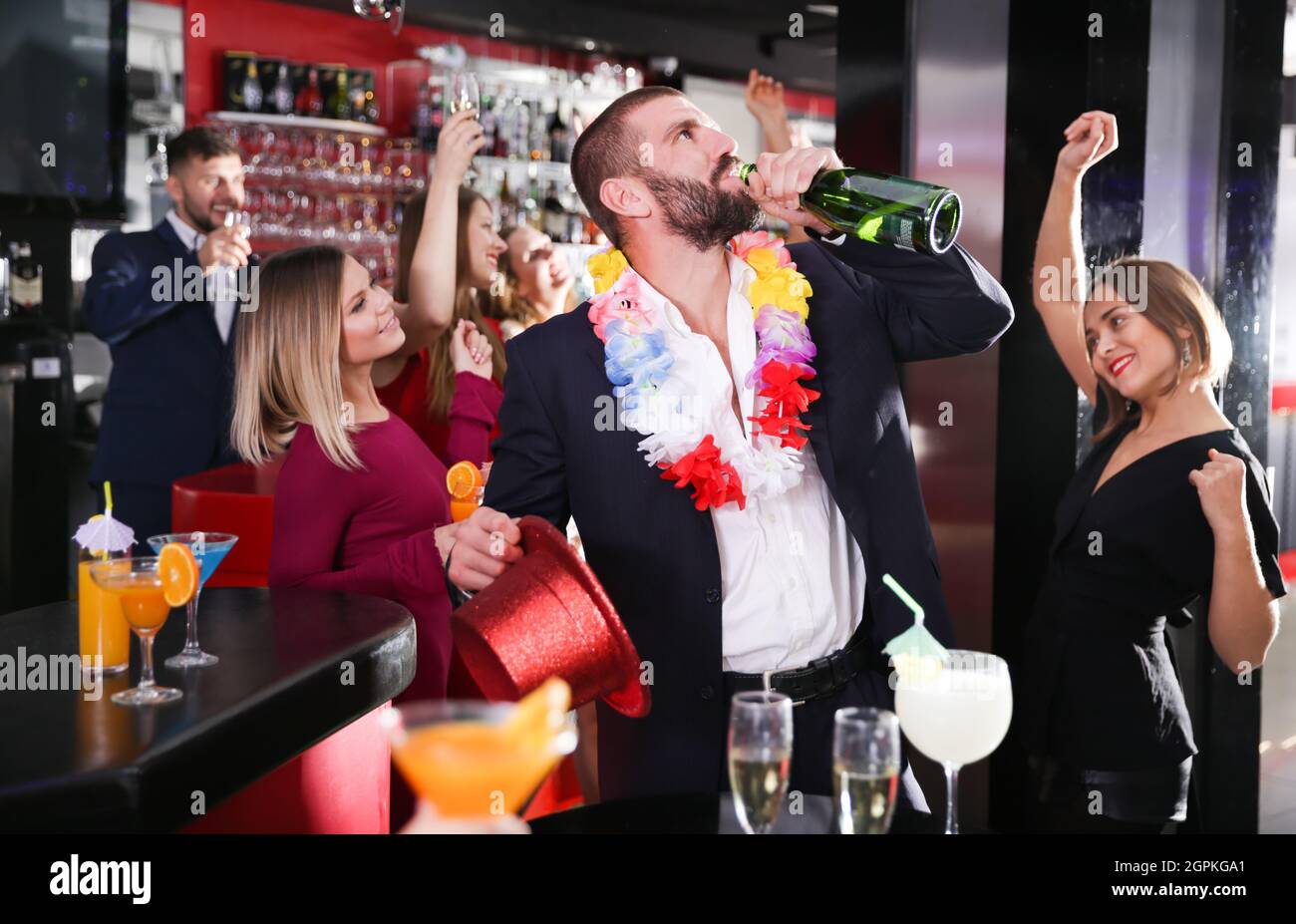 Man drinking too much on Hawaiian party Stock Photo - Alamy
