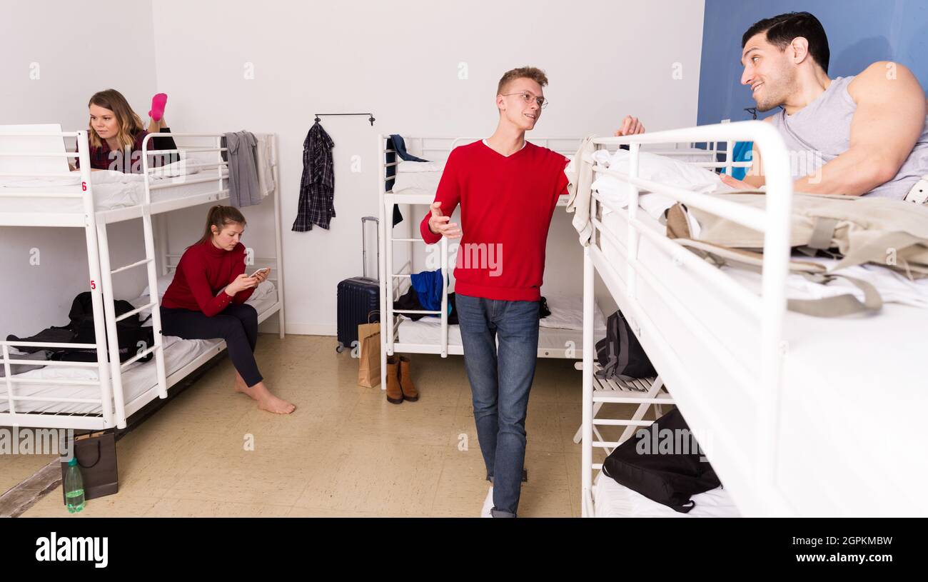 Two men talking in hostel Stock Photo - Alamy