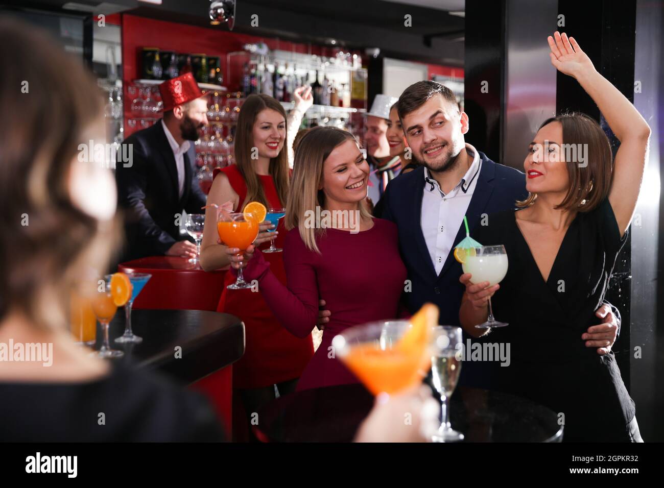 Man and two women at nightclub Stock Photo - Alamy