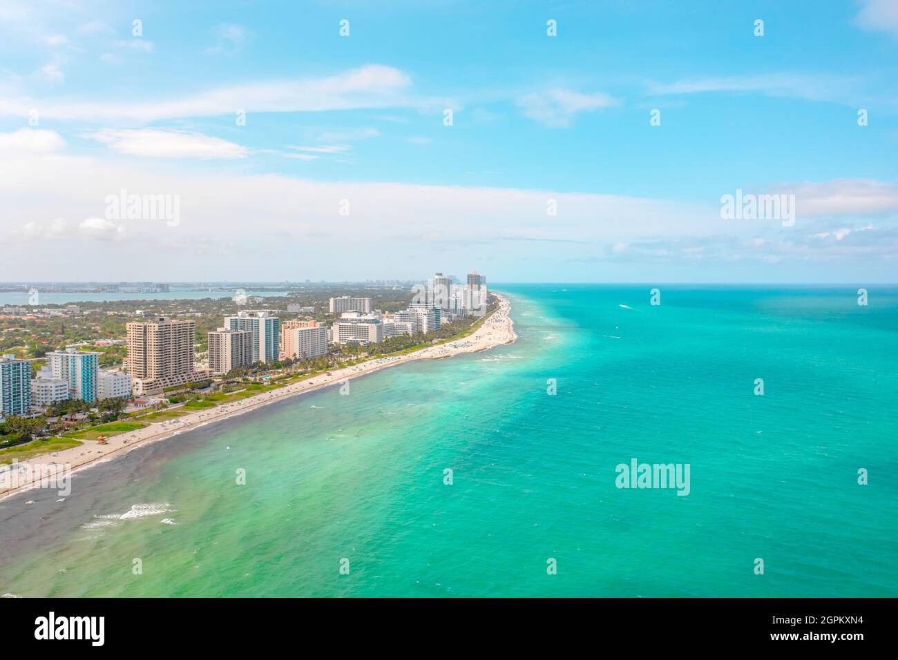 Drone point of view of Miami Beach, Florida coast line with many high ...