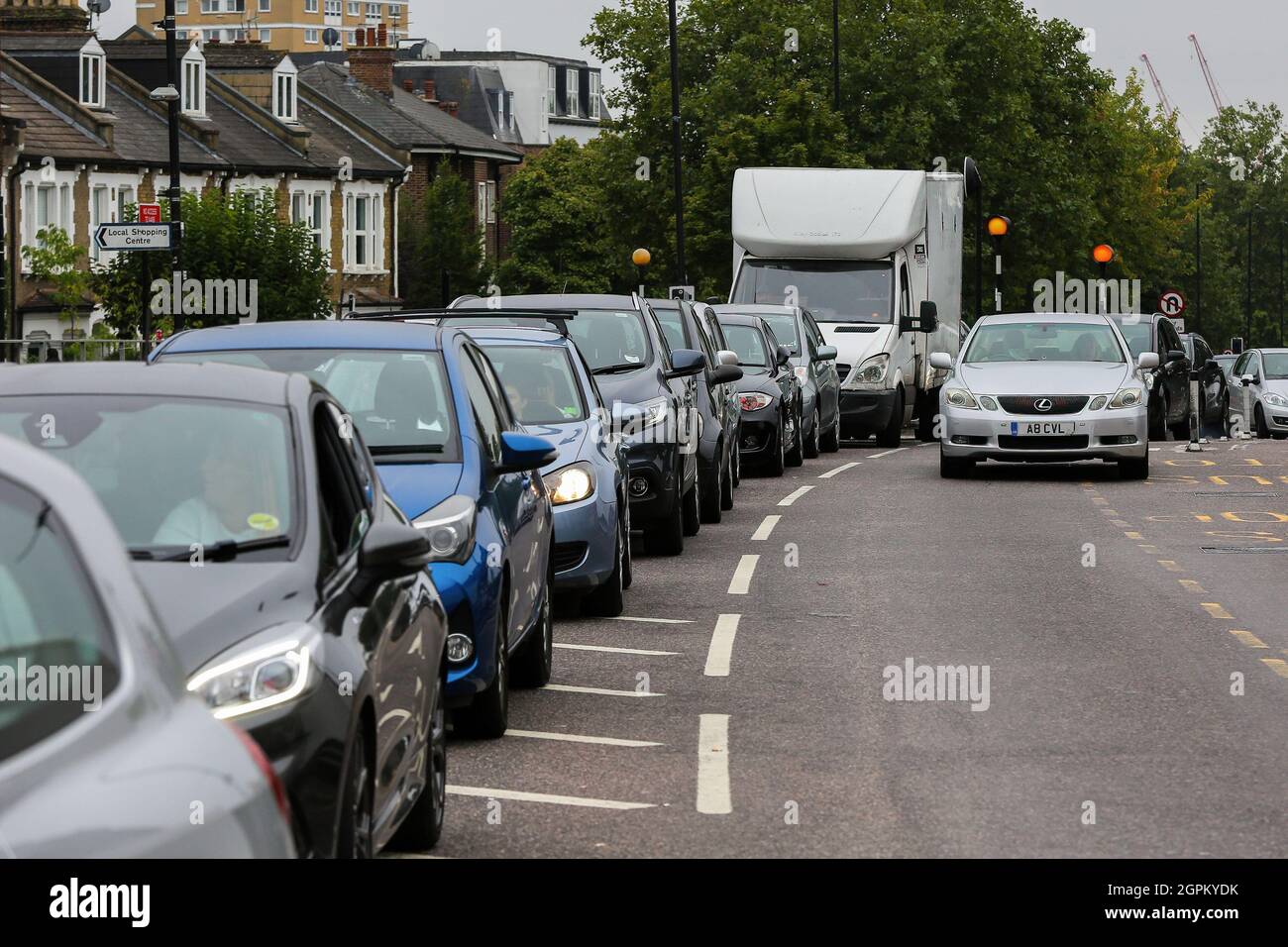 Motorists queue at a petrol station, amid fears of fuel running out due ...