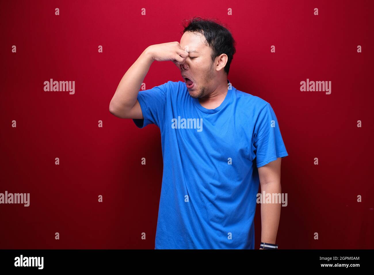 Young asian man smelling something stinky and disgusting Stock Photo ...
