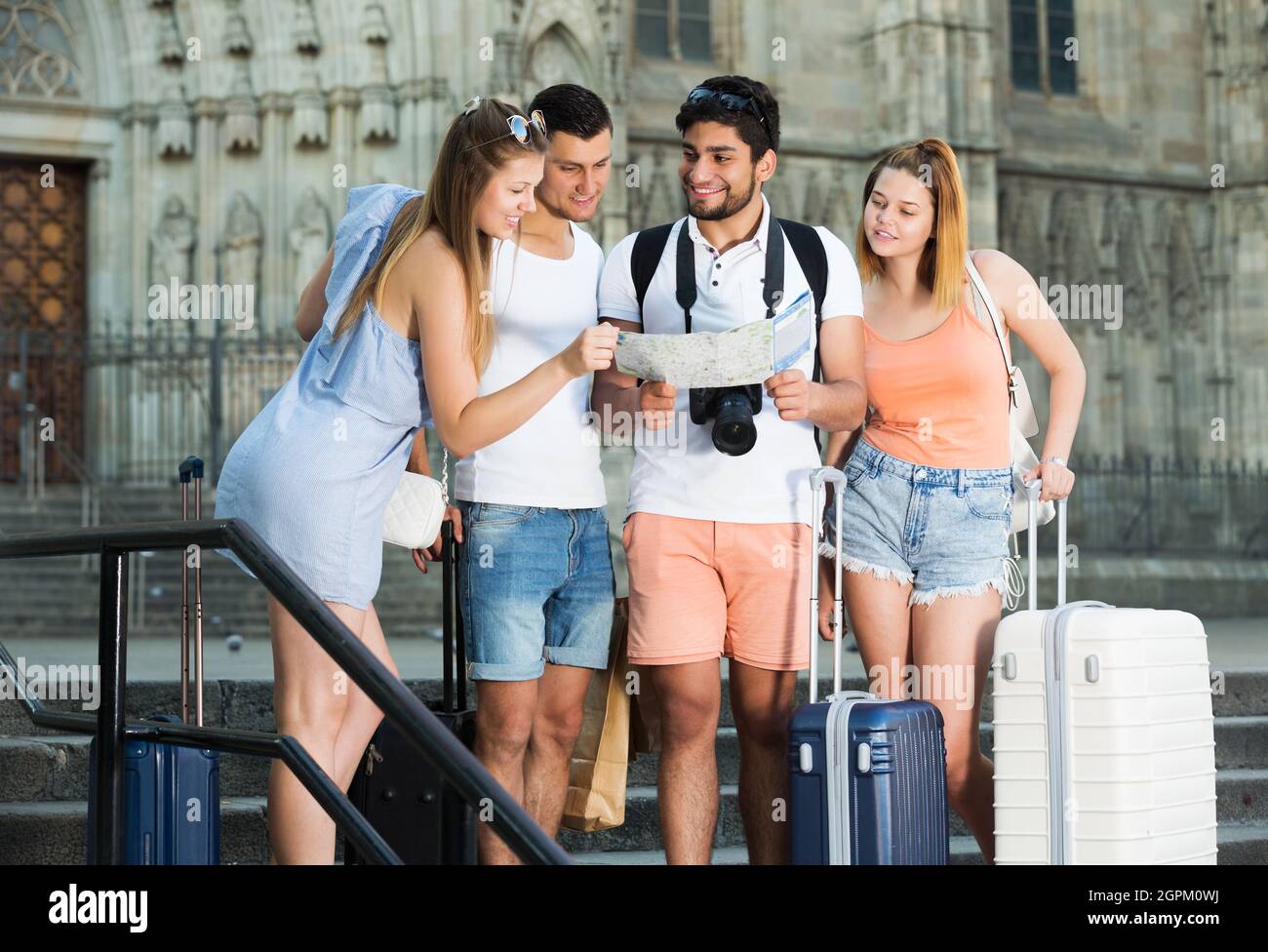 Travelers holding map and looking way Stock Photo - Alamy