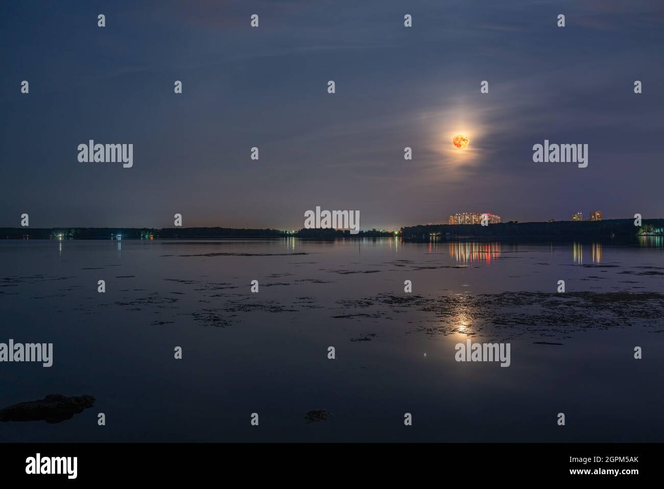 Super full blood moon and moon light over the nigt lake. Full red moon ...