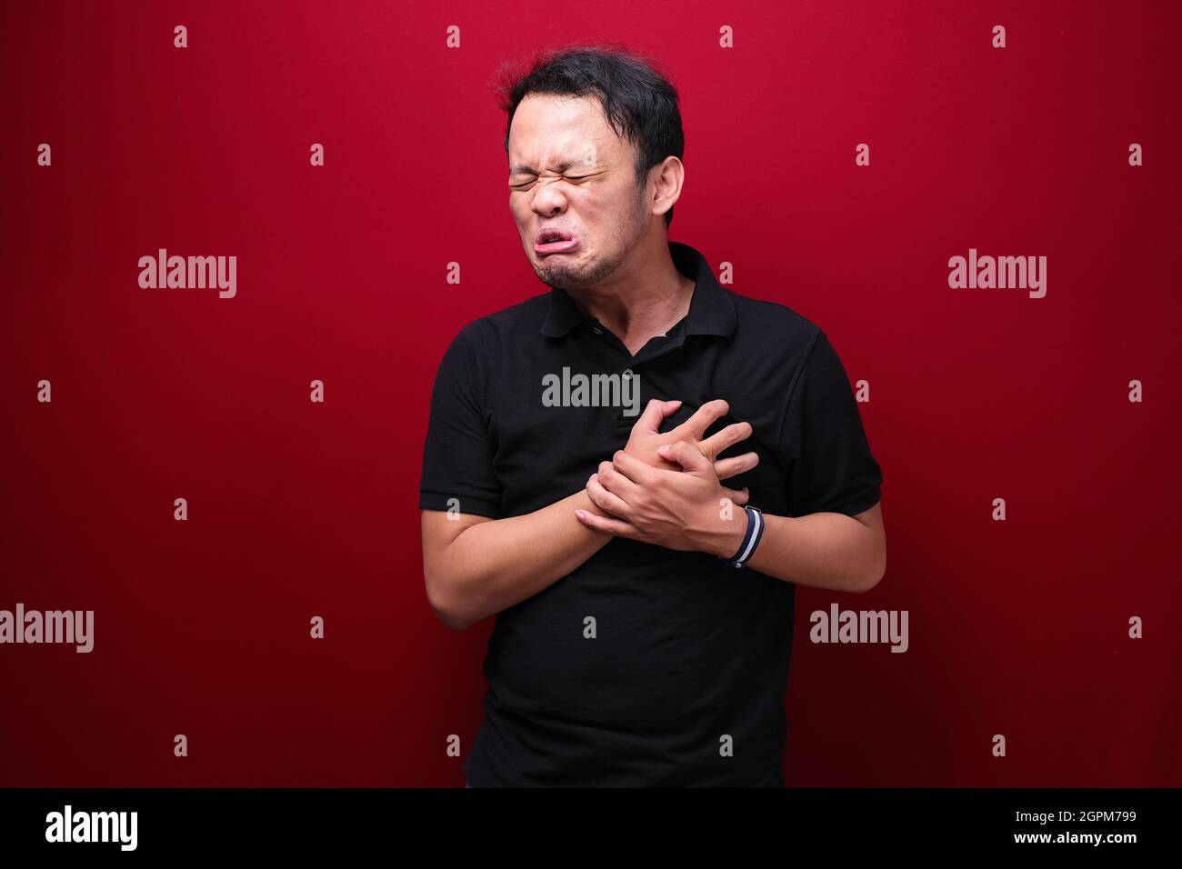 Heart attack or broken heart of young asian man with hurt emotion wear ...