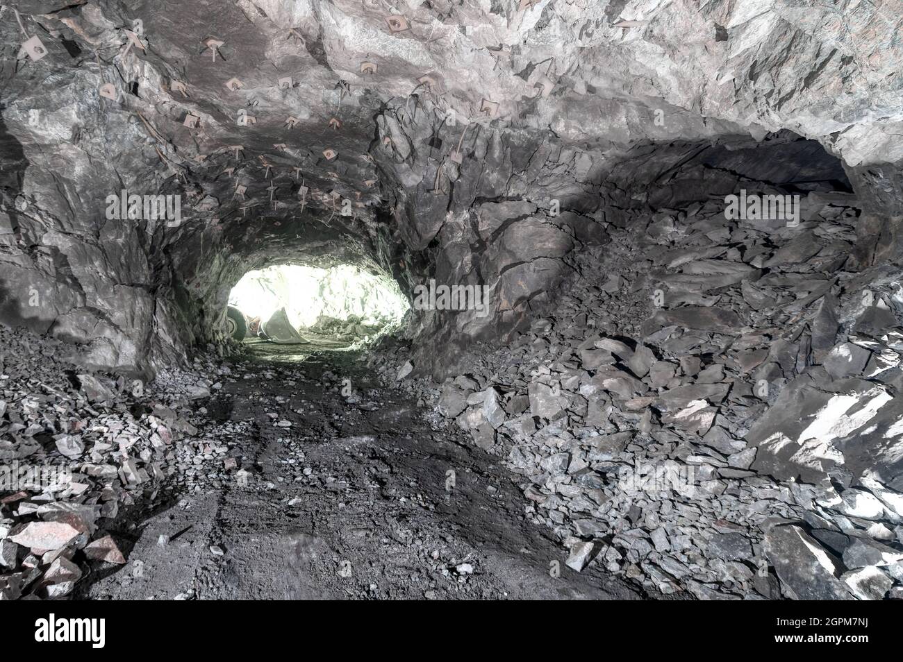 Underground mining, tunnel in the rock. There is a bright light at the ...