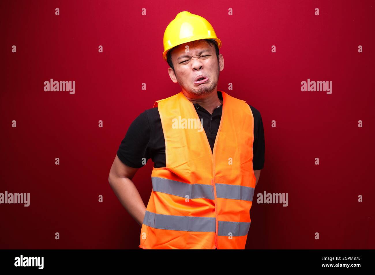 Sad and upset young asian man worker with serious pain in back man ...