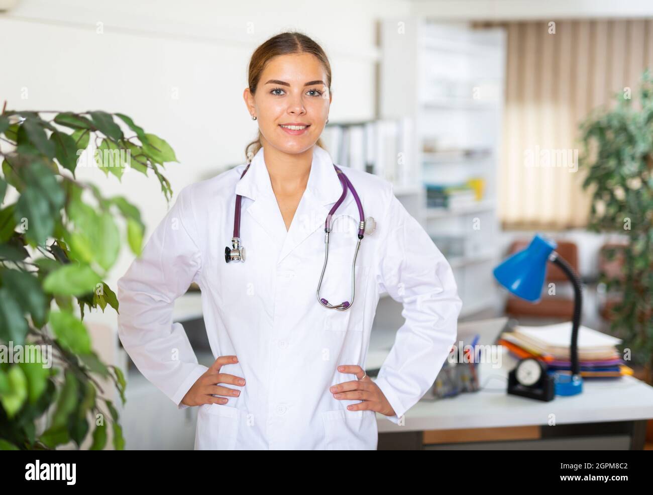 Portrait of a young female doctor standing in a resident's office Stock ...