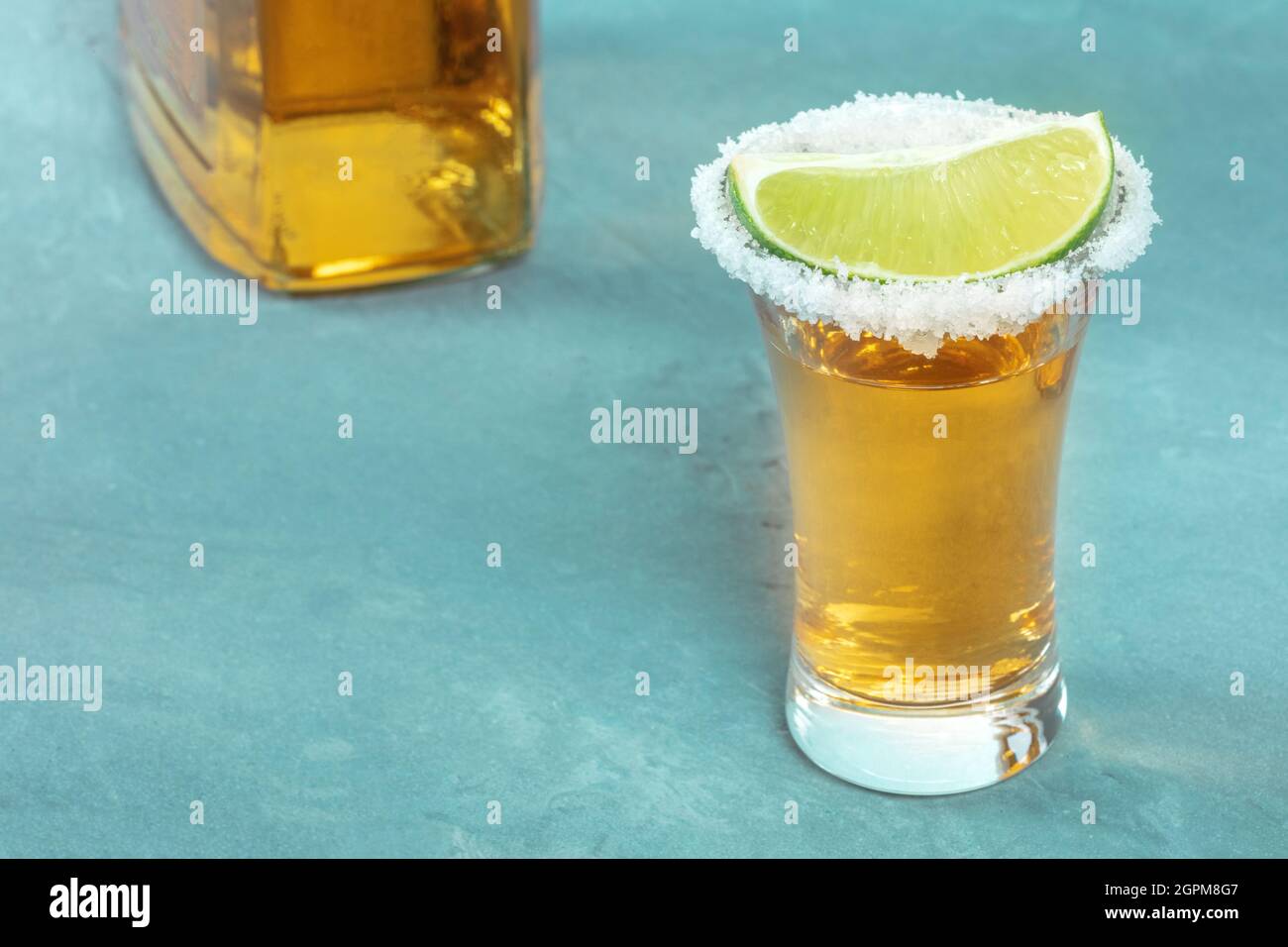 Tequila shot with a lime slice and a bottle, a Mexican drink with a ...
