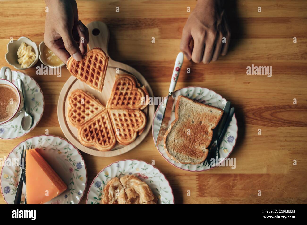 Hand pick piece fresh waffles on wood plate. Waffle and dessert concept ...
