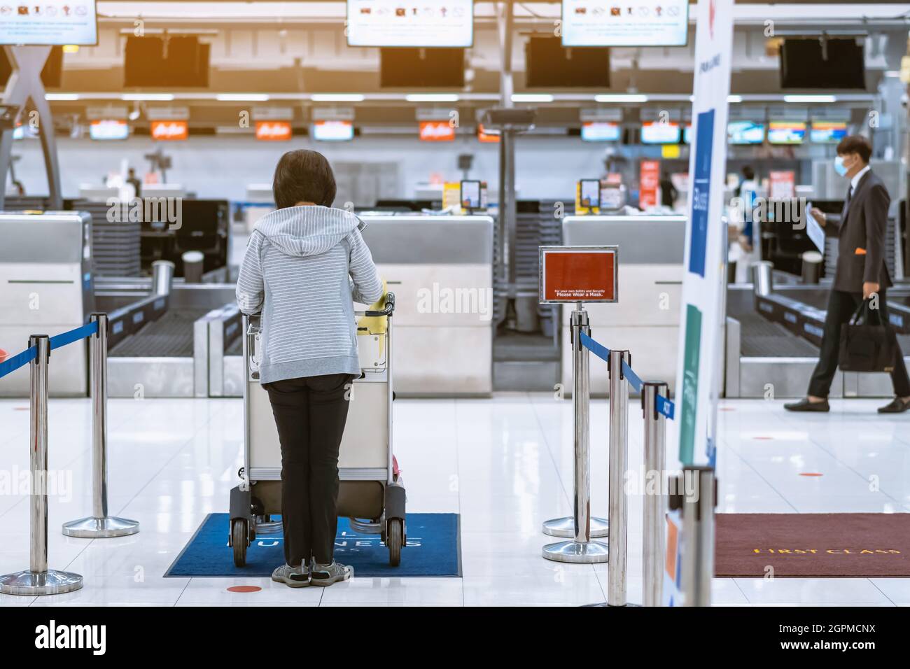 Back view of airline passenger wear face mask to prevent Corona virus ...
