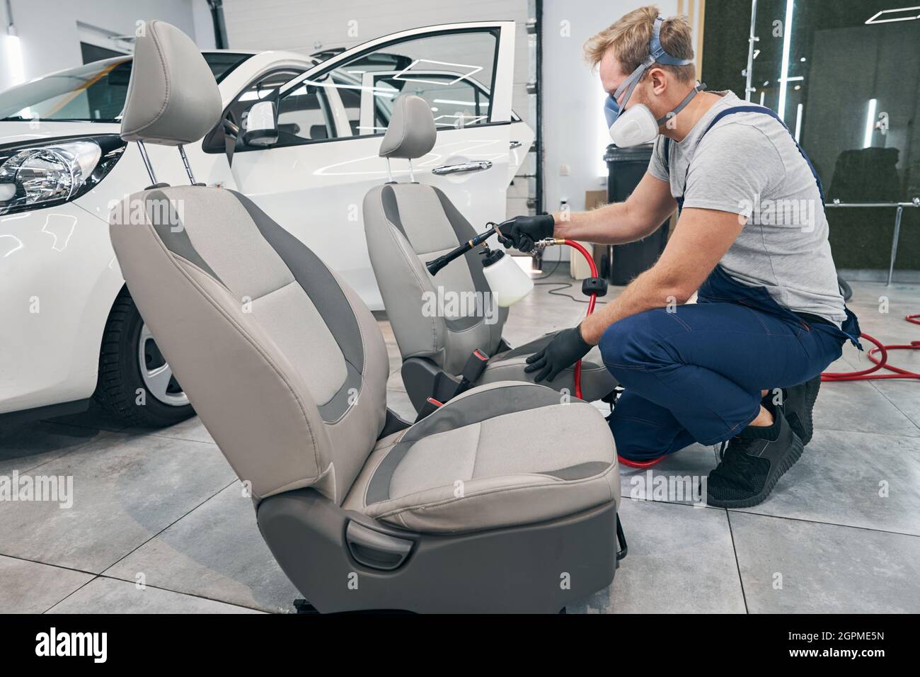 Car service worker doing chemical cleaning of seats. Detailing Stock ...