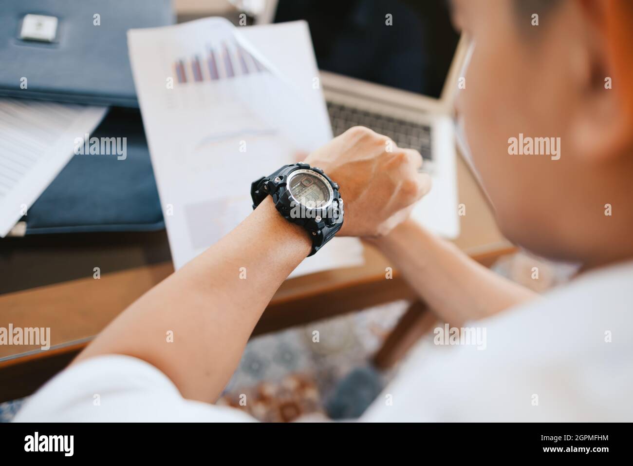 businessman looking at his watch on his hand, watching the time while ...