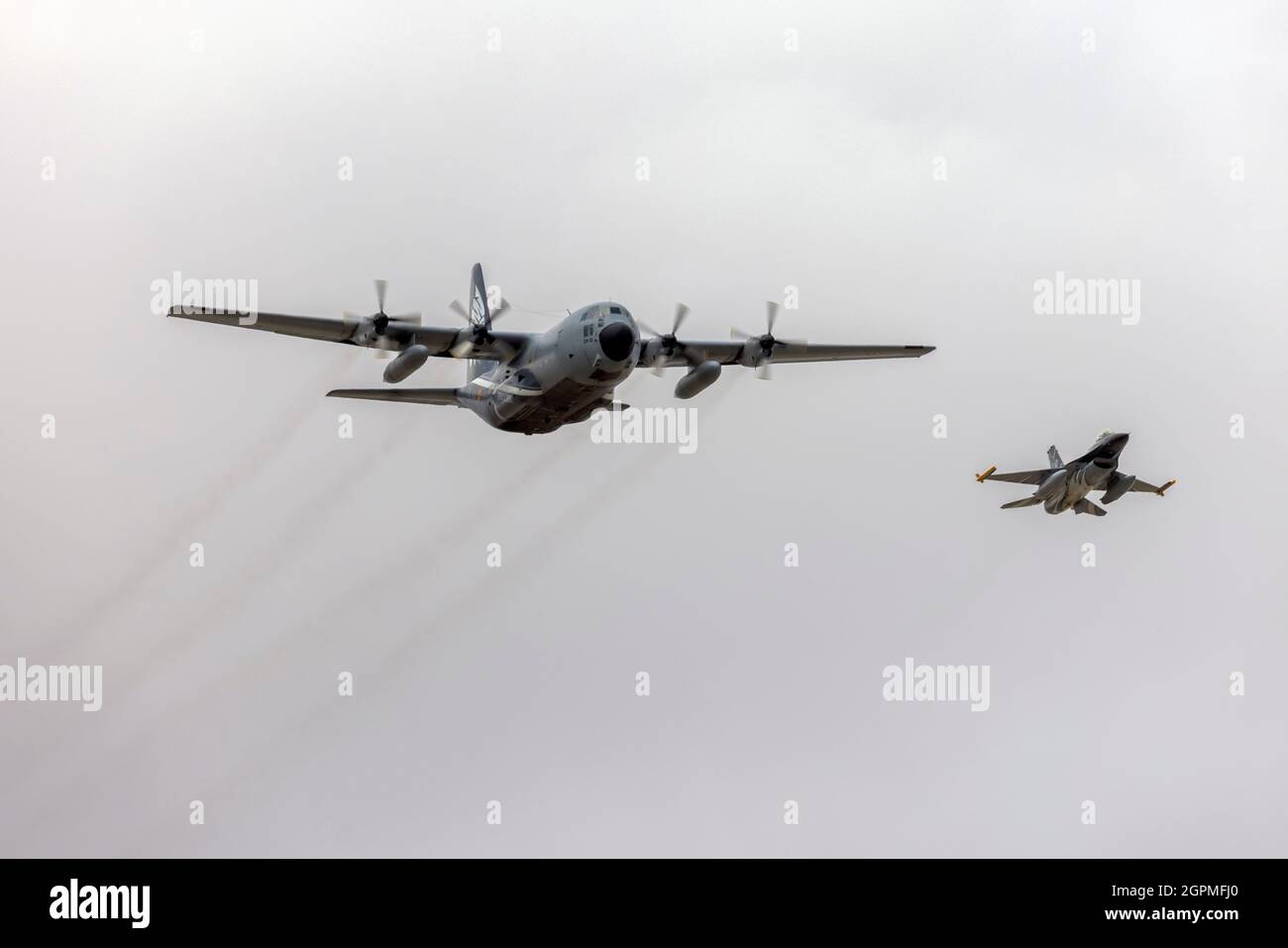 BelgianAir Force Lockheed C-130H Hercules (REG: CH-01) and F-16C flying in formation along ...