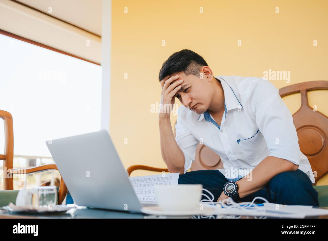 Tired businessman at workplace in office holding his headache or angry ...