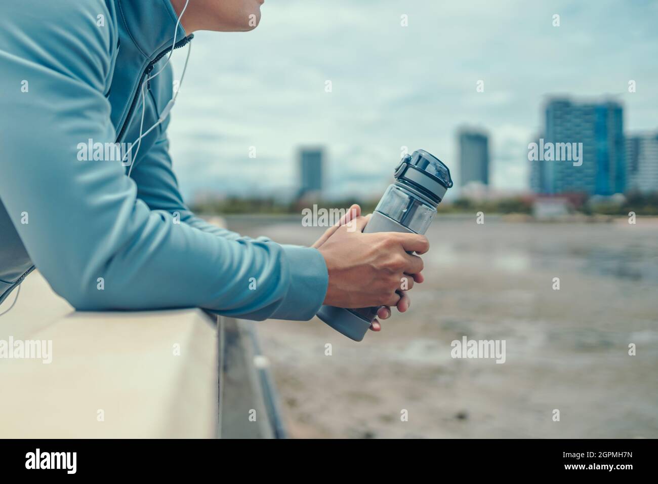sport man standing after running and holding water bottle drink. Sport ...