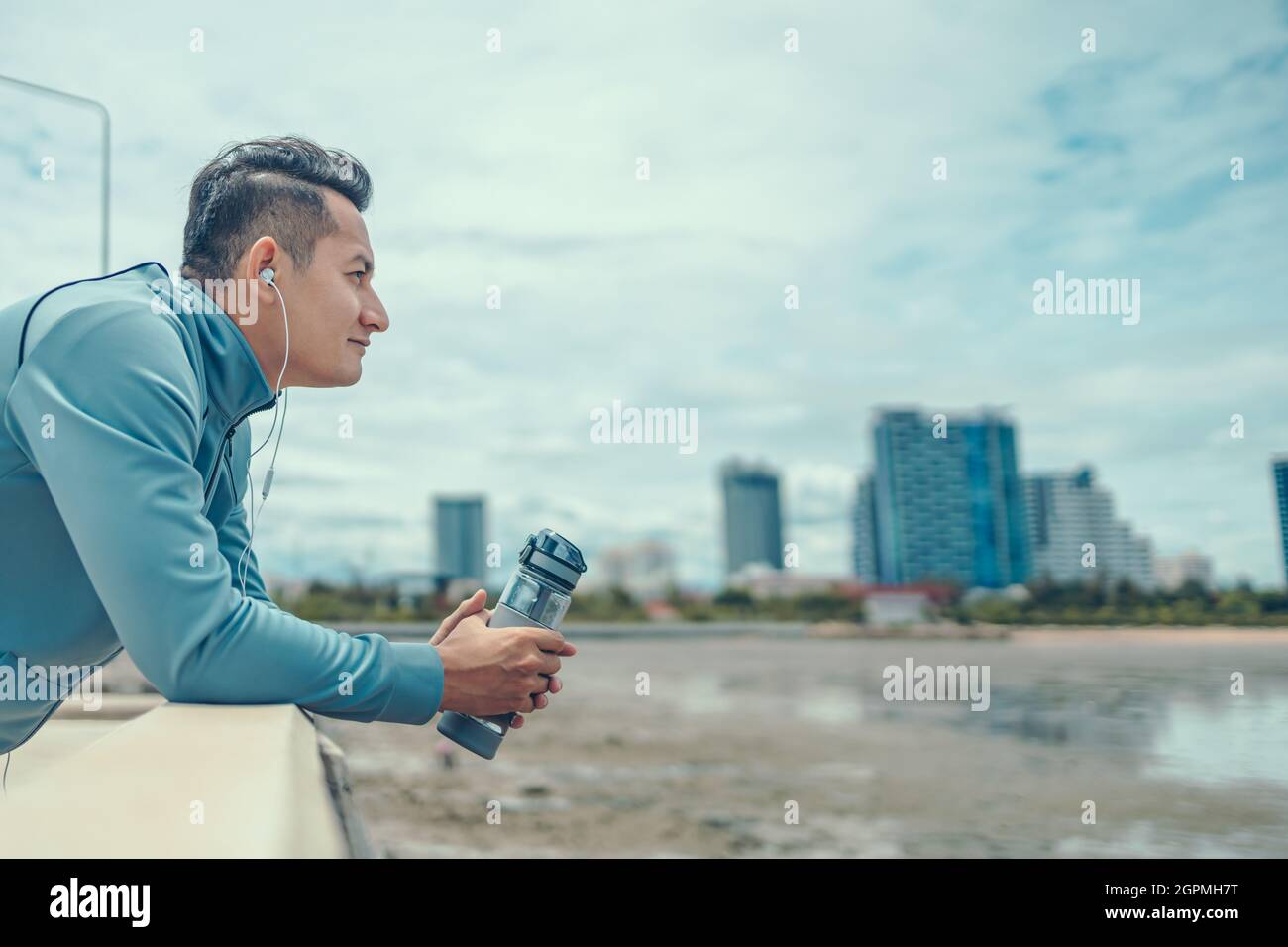 sport man standing after running and holding water bottle drink. Sport ...