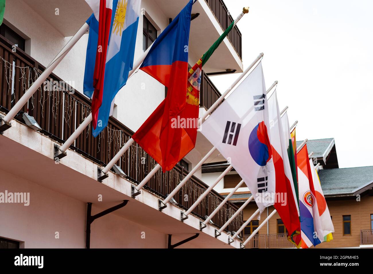 Many flags of different states fluttering on the facade of building ...