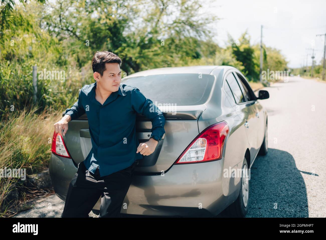 Man pushing a broken car breakdown on the road hot day. Car broken ...
