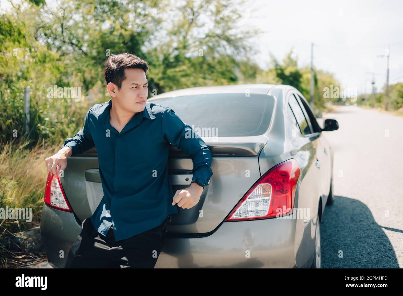 Man pushing a broken car breakdown on the road hot day. Car broken ...