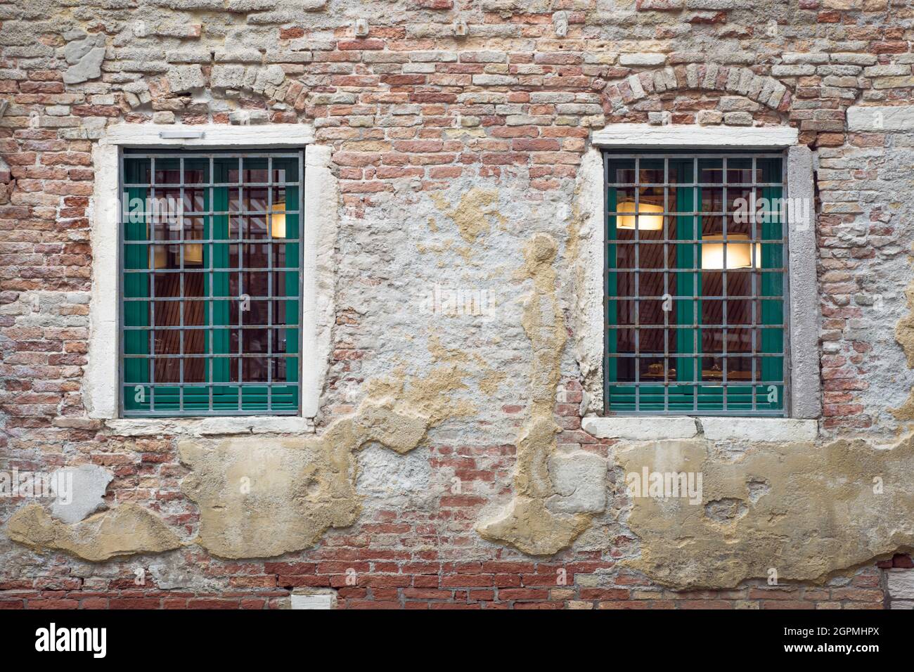 two caged windows on ancient brick wall in Venice Stock Photo - Alamy