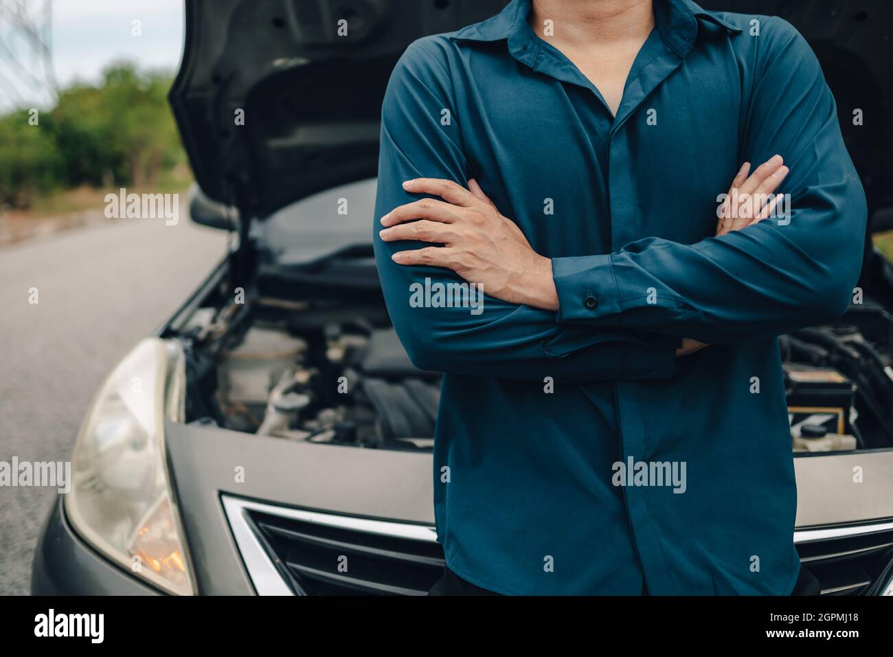 Serious man fold one’s arms over the chest front of car breakdown and ...