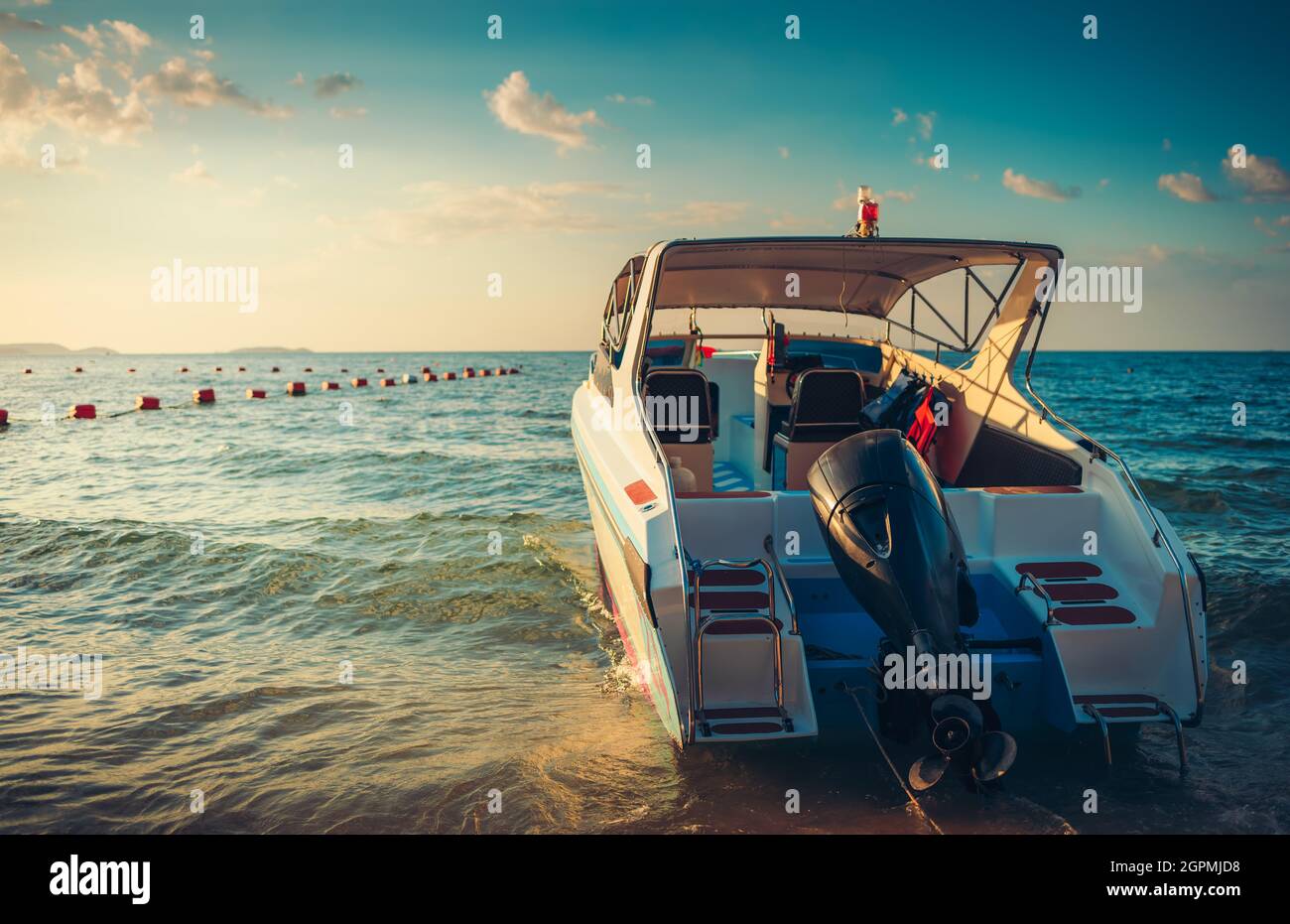Speed boat at the sea beach and sunset Stock Photo - Alamy