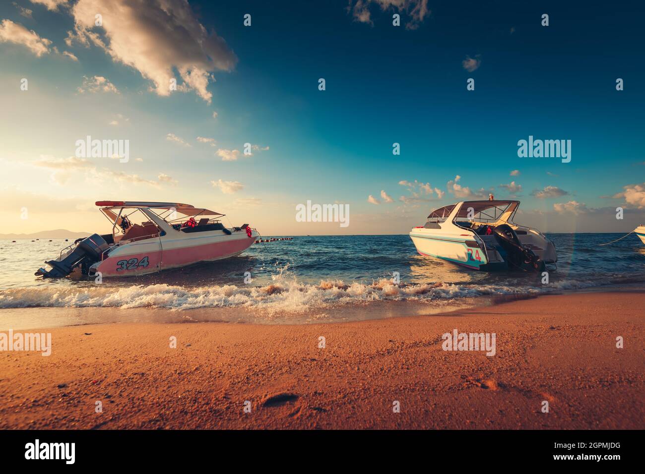 Speed boat at the sea beach and sunset Stock Photo - Alamy