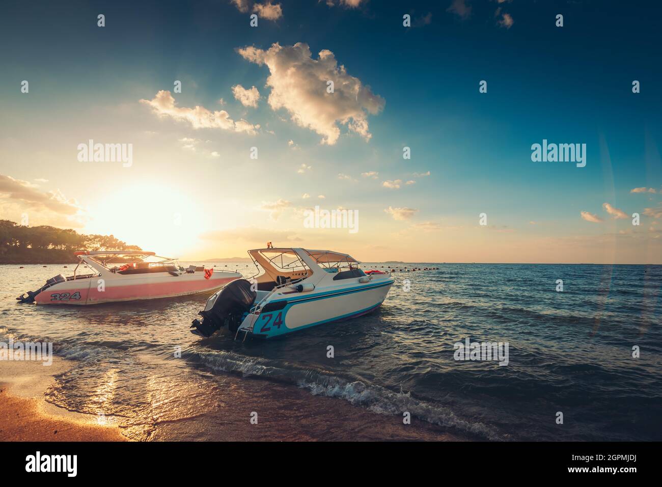 Speed boat at the sea beach and sunset Stock Photo - Alamy
