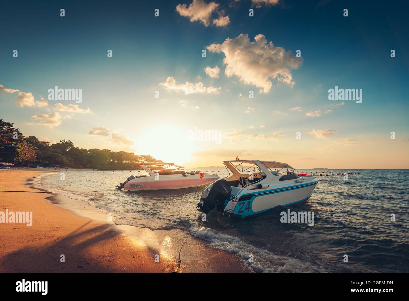 Speed boat at the sea beach and sunset Stock Photo - Alamy