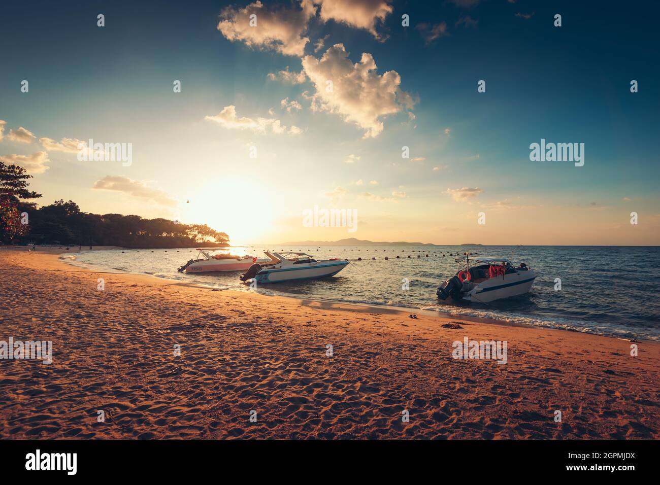 Speed boat at the sea beach and sunset Stock Photo - Alamy