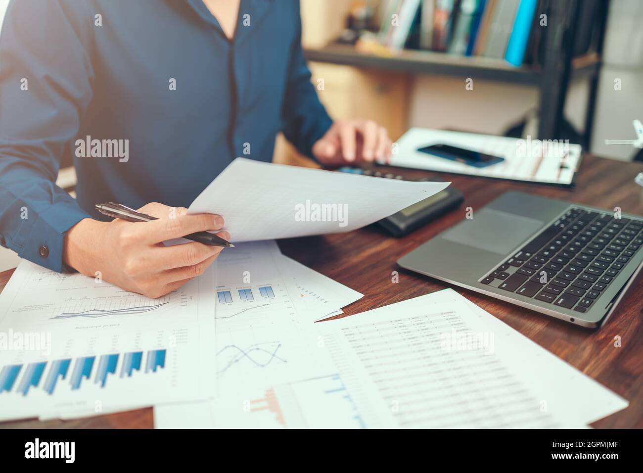 Accounting woking with data sheet on the office desk. Calculator with ...
